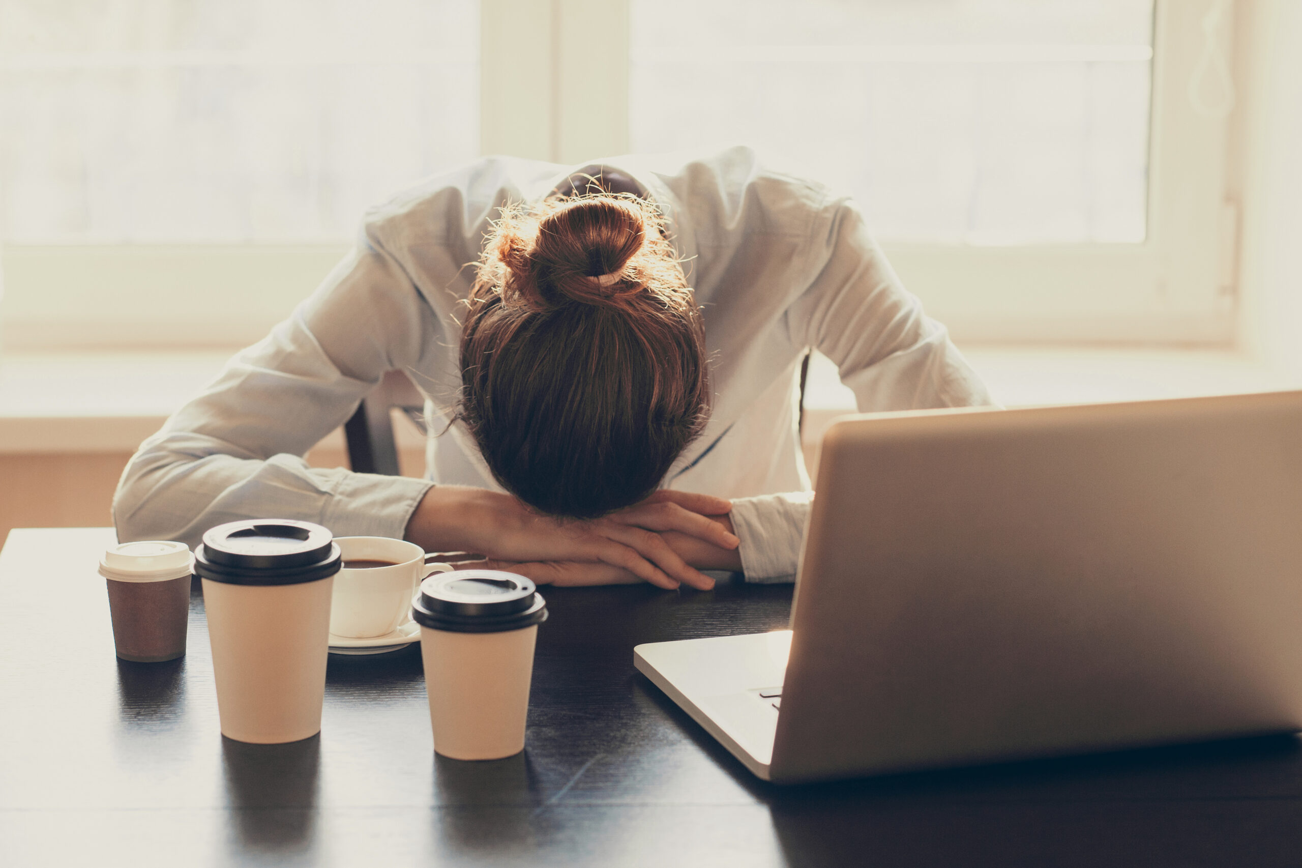 Tired woman in the office | OU News | Open University